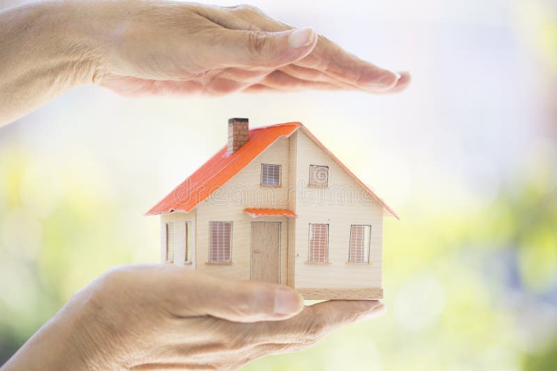 A Hand Holding a Small Model House. Home Protection Concept Stock Image ...