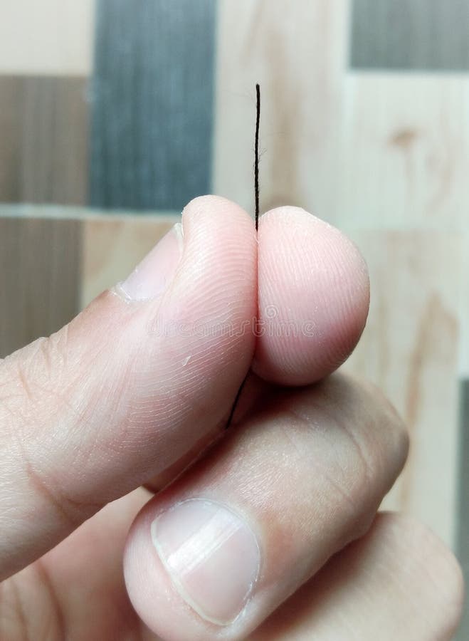 Hand Holding a Small Piece of Thread Ready for Crafting or Sewing ...