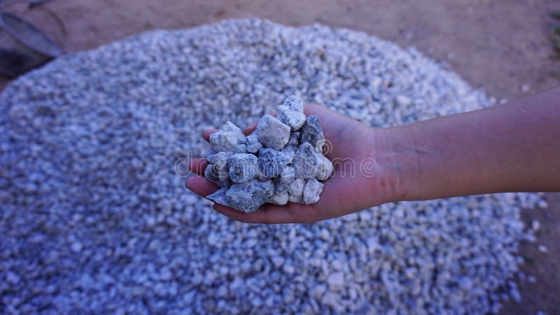 Hand Holding a Small Stone for Use in Construction Stock Image - Image ...