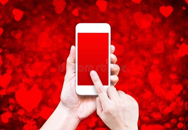 Hand Holding Smart Phone with Black Red Screen on Red Heart Bokeh ...