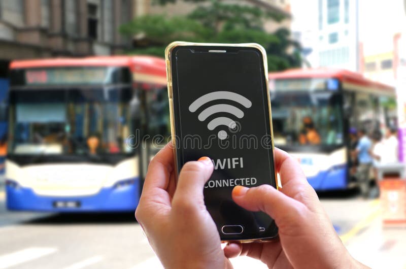 Hand Holding Smart Phone at Bus Stop Stock Image - Image of modern ...