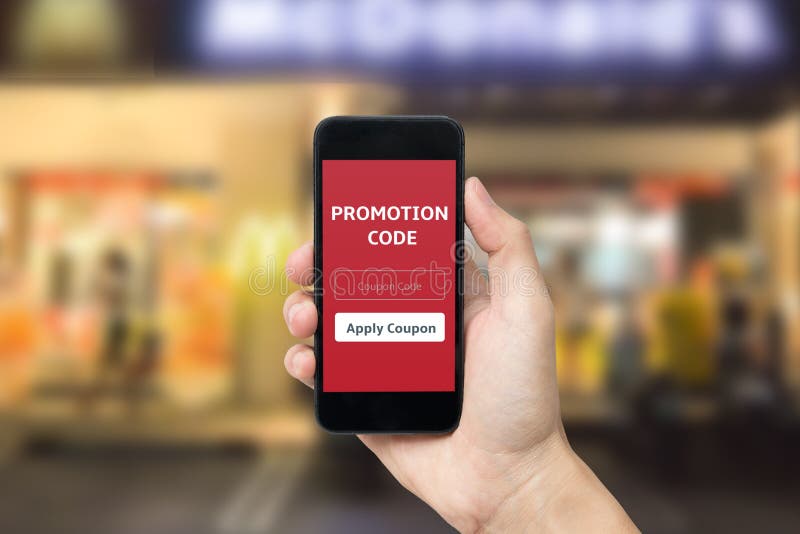 Hand Holding Smart Phone with Promotion Code Application Stock Image ...