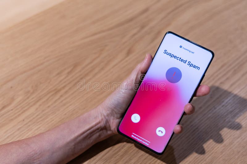 Hand Holding Smart Phone with Suspected Spam Incoming Call Warning ...