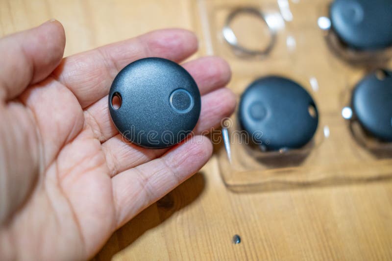 Hand Holding Smart Tracker Device, Symbolizing Personal Item Tracking ...