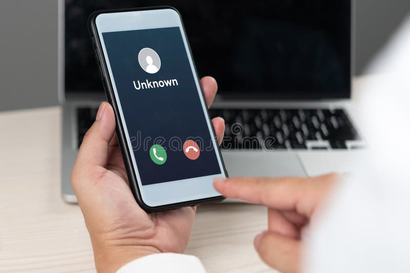 Hand Holding a Smartphone Displaying an Incoming Call from an Unknown ...