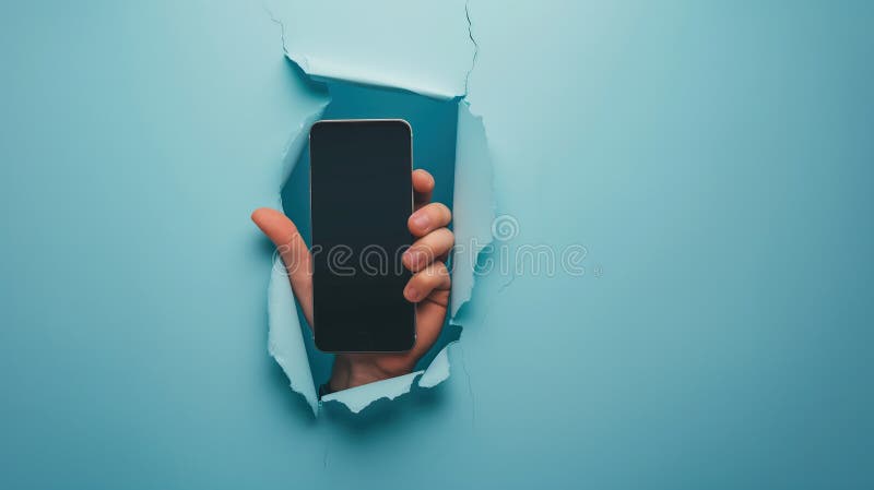 Hand Holding a Smartphone through a Hole in Blue Paper with Space for ...