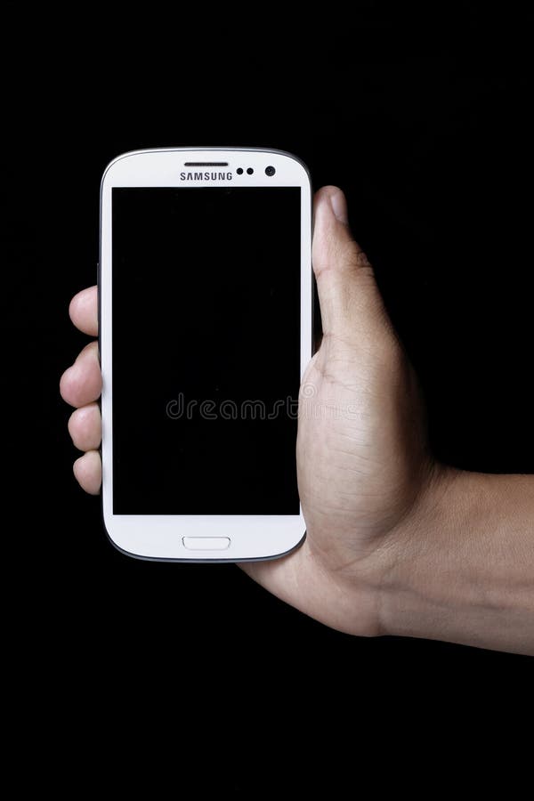 Hand holding smartphone editorial stock image. Image of technology ...