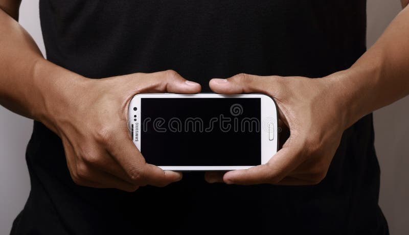 Hand holding smartphone editorial stock photo. Image of touch - 50304223