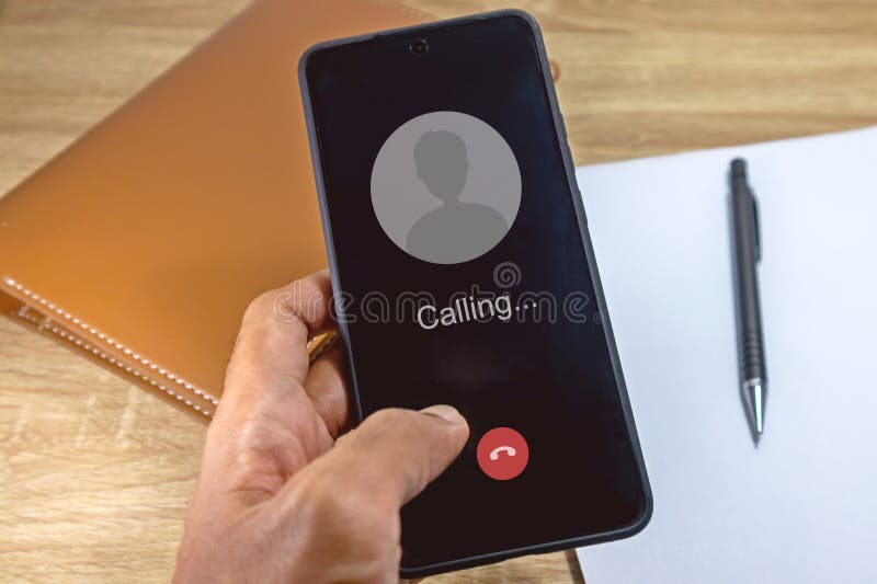 Hand Holding a Smartphone with Outgoing Call Screen Concept. Call ...