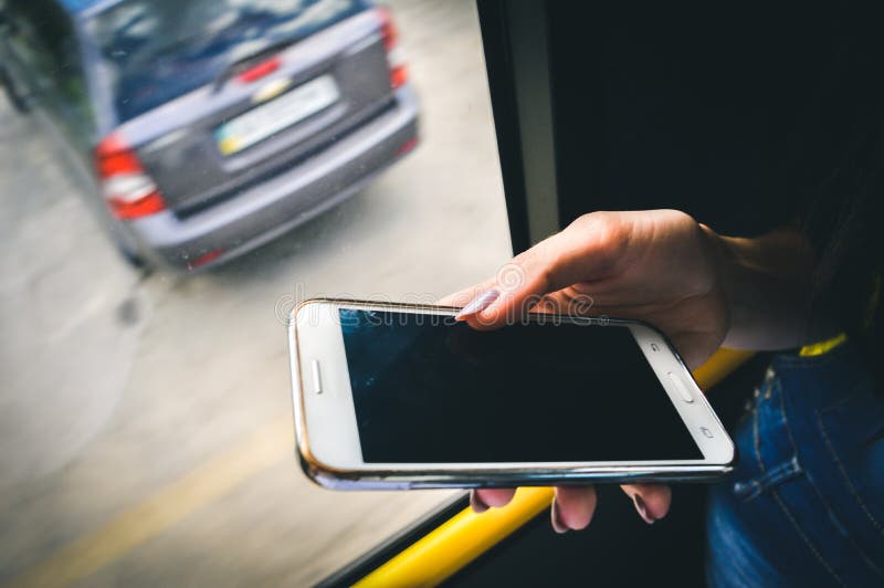 Hand Holding Smartphone in Public Transport Stock Photo - Image of ...
