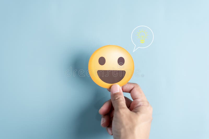 Hand Holding Smile Face Emoticon Paper Cut with Light Bulb Smart Idea ...
