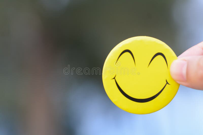 A Hand Holding a Smiling Face Symbolizes a Positive Mindset ...
