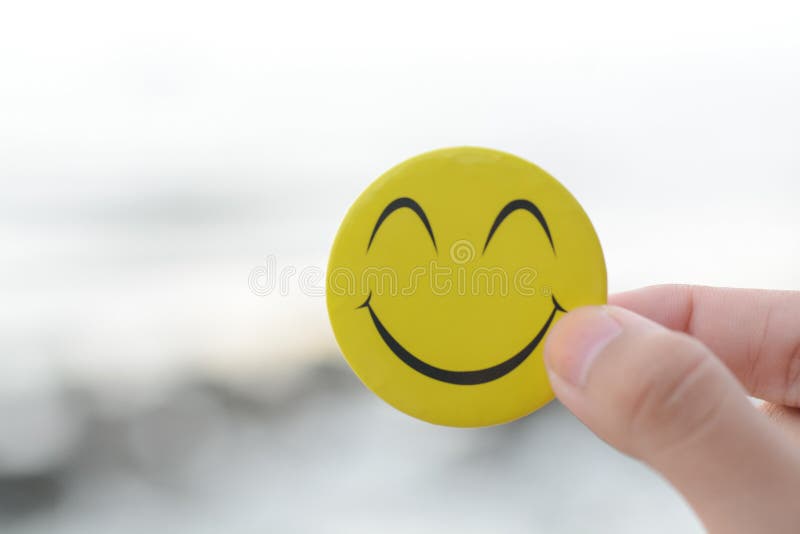 A Hand Holding a Smiling Face Symbolizes a Positive Mindset ...