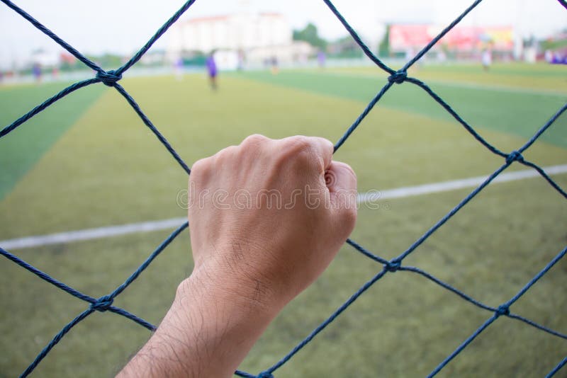 Hand holding soccer net stock image. Image of recreational - 41166209
