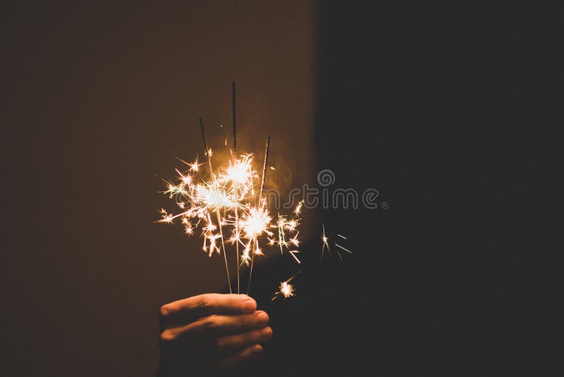 Hand holding fireworks stock photo. Image of sparkle - 247482138