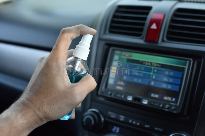 Hand Holding a Spray Bottle of Alcohol Inside the Car Stock Photo ...