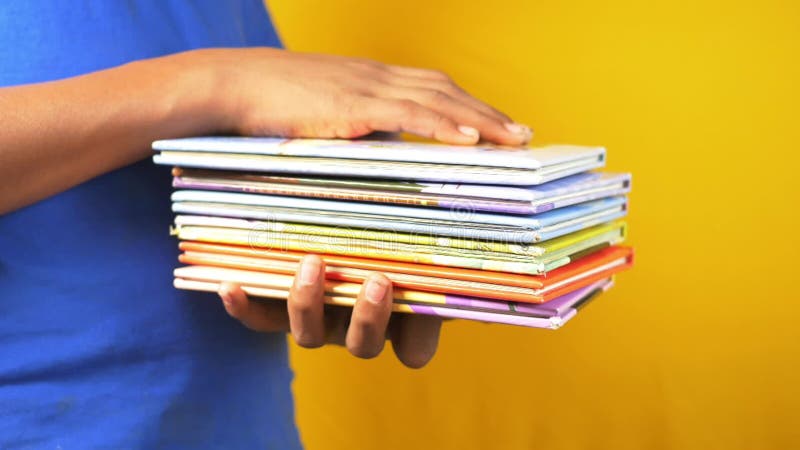 Hand Holding Stack of Books on Color Background Stock Footage - Video ...