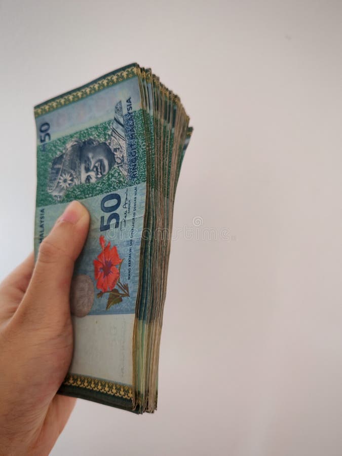 A Hand Holding a Stack of Malaysian Ringgit Banknotes Stock Photo ...