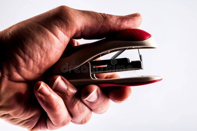 A Hand Holding a Stapler with a Red and White Handle Stock Photo ...