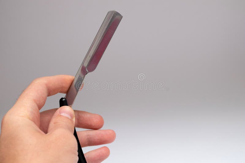 Hand Holding a Straight Razor on a White Background Stock Photo - Image ...