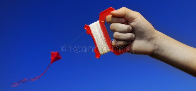Hand Holding String with Kite Flying in Blue Sky Stock Photo - Image of ...