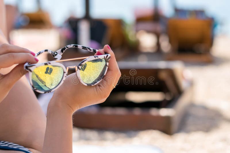 Hand holding sunglasses stock image. Image of sunbathing - 146916811