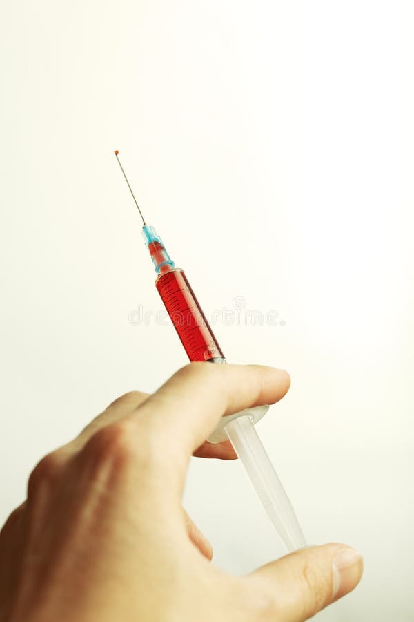 Hand holding a syringe stock photo. Image of equipment - 14145066