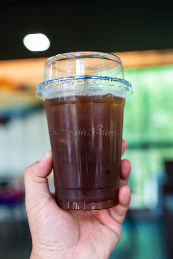 Hand Holding a Take Out Iced Black Coffee Stock Image - Image of crop ...