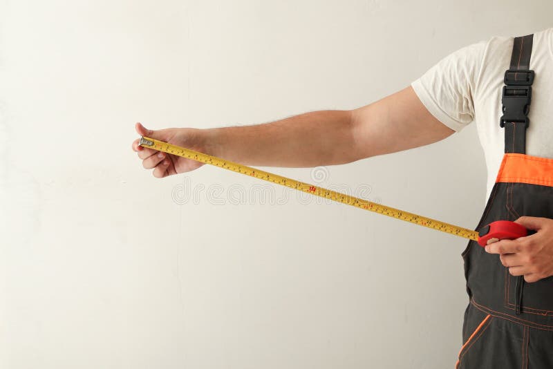 Hand Holding Tape Measure Profile. Construction Worker Measuring Wall ...