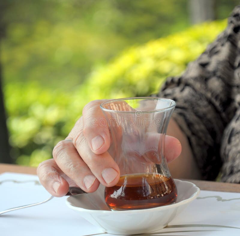 Hand holding tea glass stock photo. Image of black, herbal - 20622746