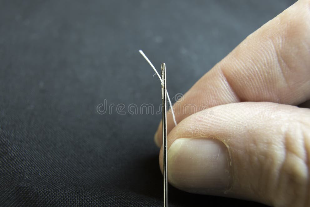 Hand Holding Thread in Needle Eye Stock Photo - Image of threading ...