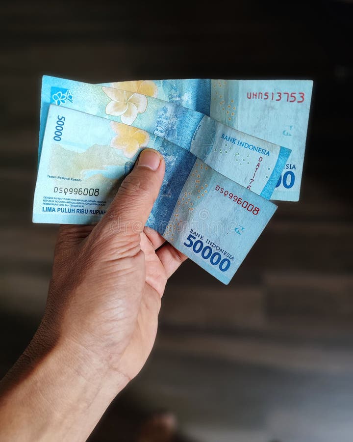 A Hand Holding Three 50,000 Indonesian Rupiah Banknotes. Stock Photo ...