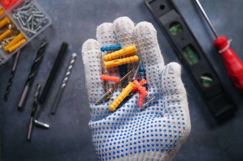 A Hand Holding Tools and Fasteners for Various Home Improvement ...