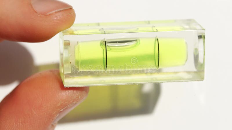 Hand Holding a Transparent Level Tool with Liquid Bubble for ...