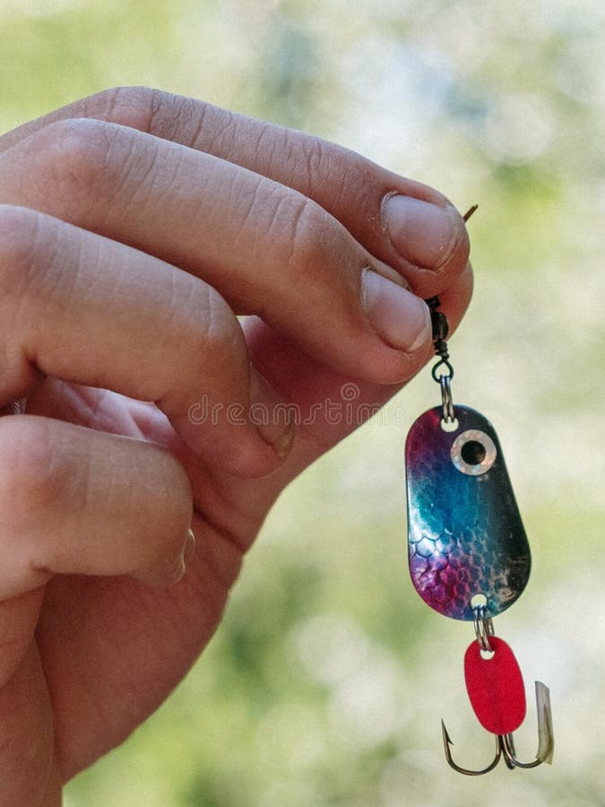 A Hand Holding a Triple Hook in the Form of a Fish Stock Image - Image ...