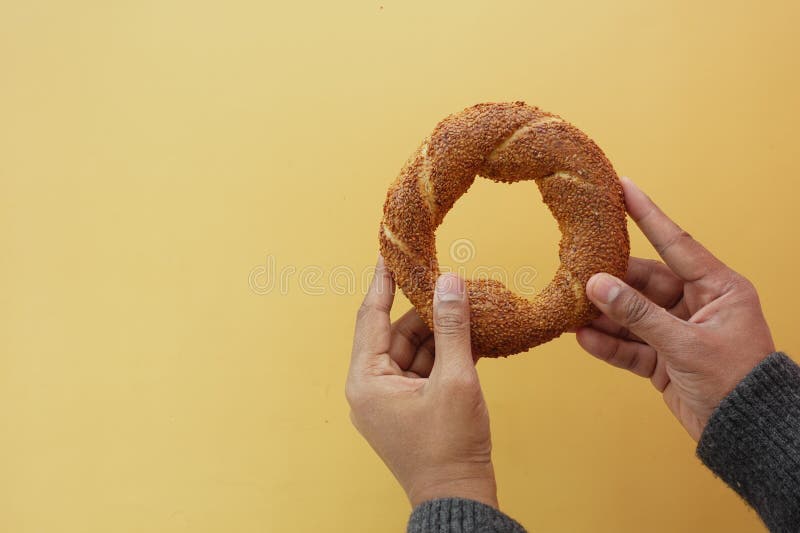 Hand Holding a Turkish Bagel Simit Stock Photo - Image of turkish, food ...