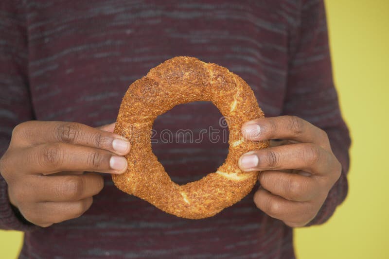 Hand Holding a Turkish Bagel Simit Stock Photo - Image of food ...