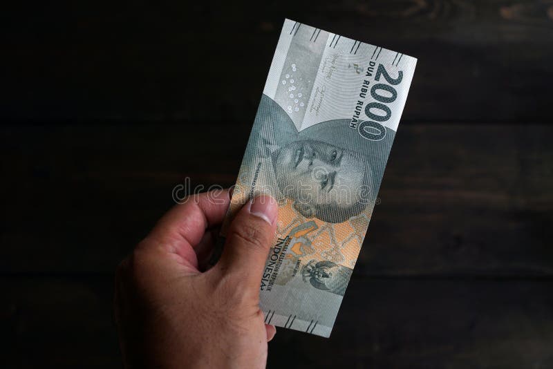 Hand Holding 2000 or Two Thousand Rupiah Indonesian Money Stock Photo ...