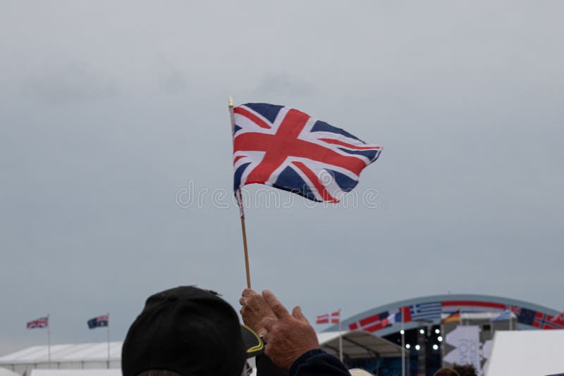 A Hand Holding Up a Union Jack or British Flag Stock Image - Image of ...