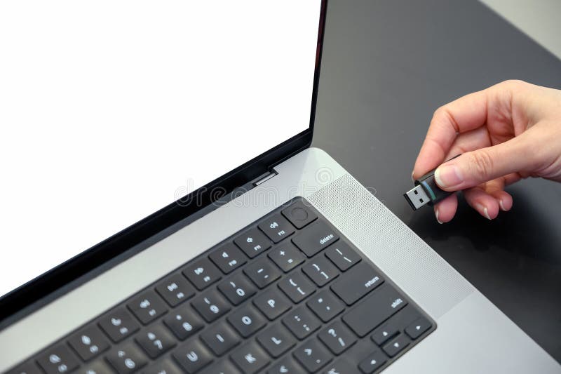 A Hand is Holding a Usb Flash Drive Over a Laptop Keyboard with a Blank ...