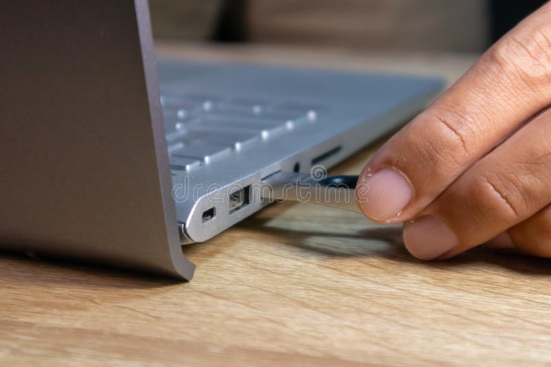 Hand Holding a USB Flash Drive To Connect To a USB Port on a Laptop ...