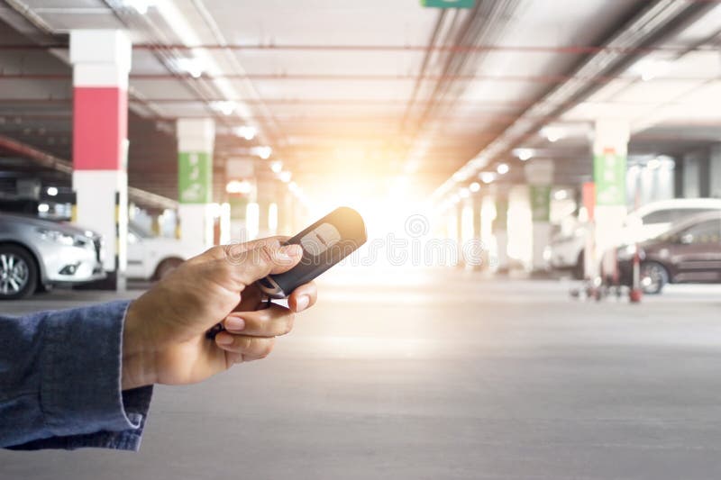 Hand Holding and Using Key Remote Control of Car Stock Photo - Image of ...
