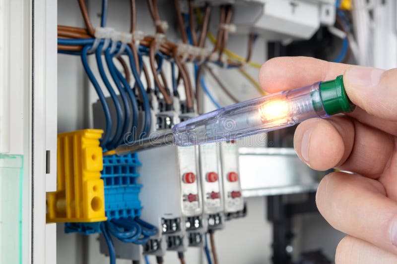 Hand Holding Voltage Tester in Electrical Panel Stock Photo - Image of ...