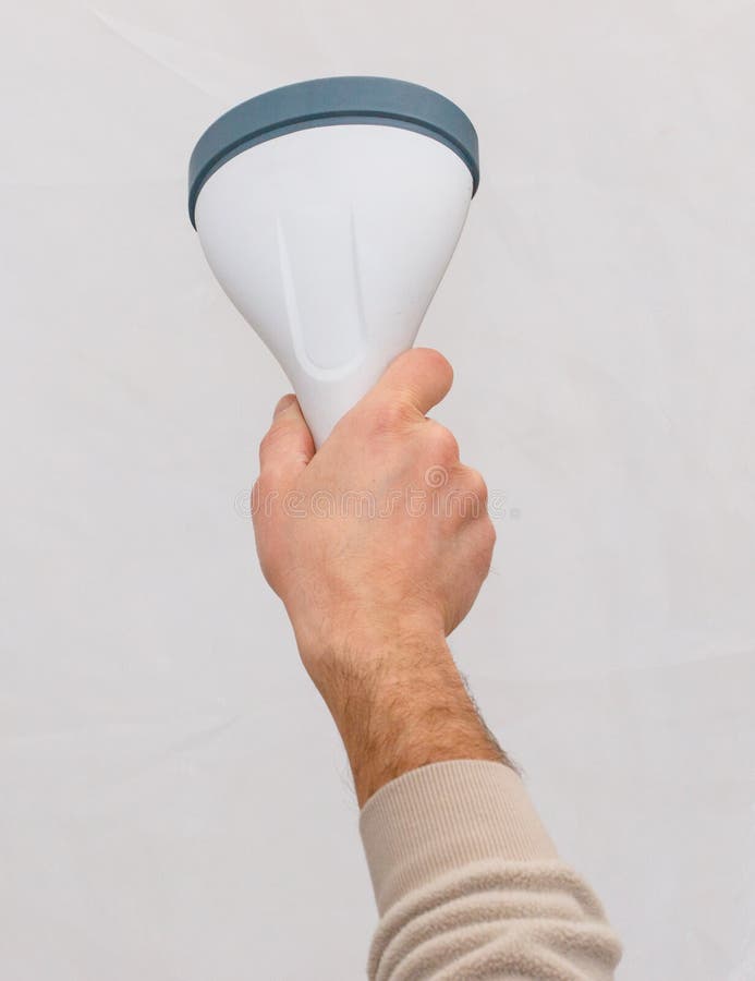 A Hand Holding a White and Blue Device Stock Image - Image of person ...