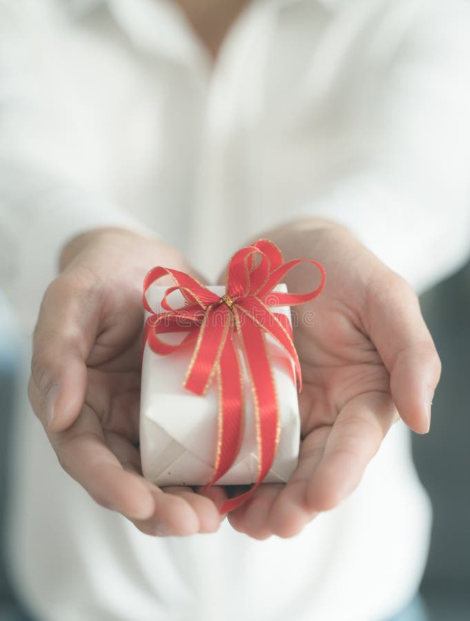 Hand Holding White Gift Box with Red Ribbon Stock Image - Image of ...