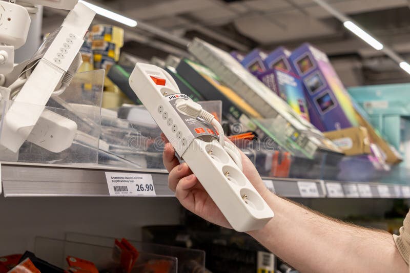 Hand Holding a White PRIMA Multi-socket Extension Cord with a Switch ...