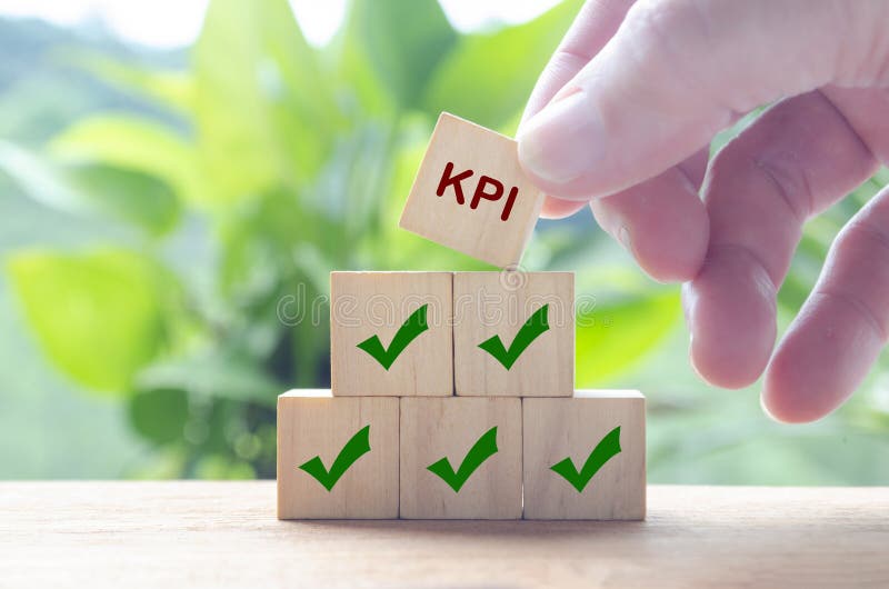 Hand Holding Wooden Cube with Text KPI. Key Performance Indicator ...