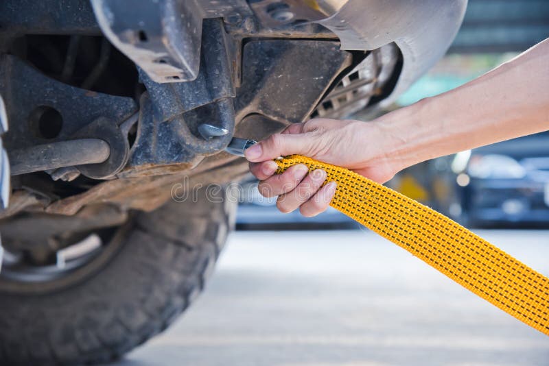 Hand Holding Yellow Car Towing Strap with Car Stock Photo - Image of ...