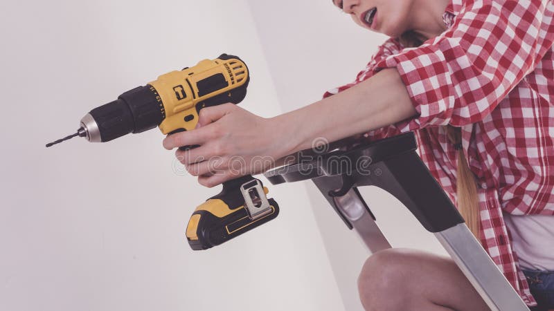 Hand holding yellow drill stock photo. Image of repair - 141037128