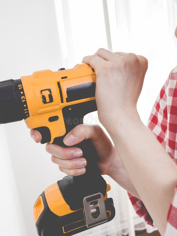 Hand holding yellow drill stock image. Image of yellow - 165357109